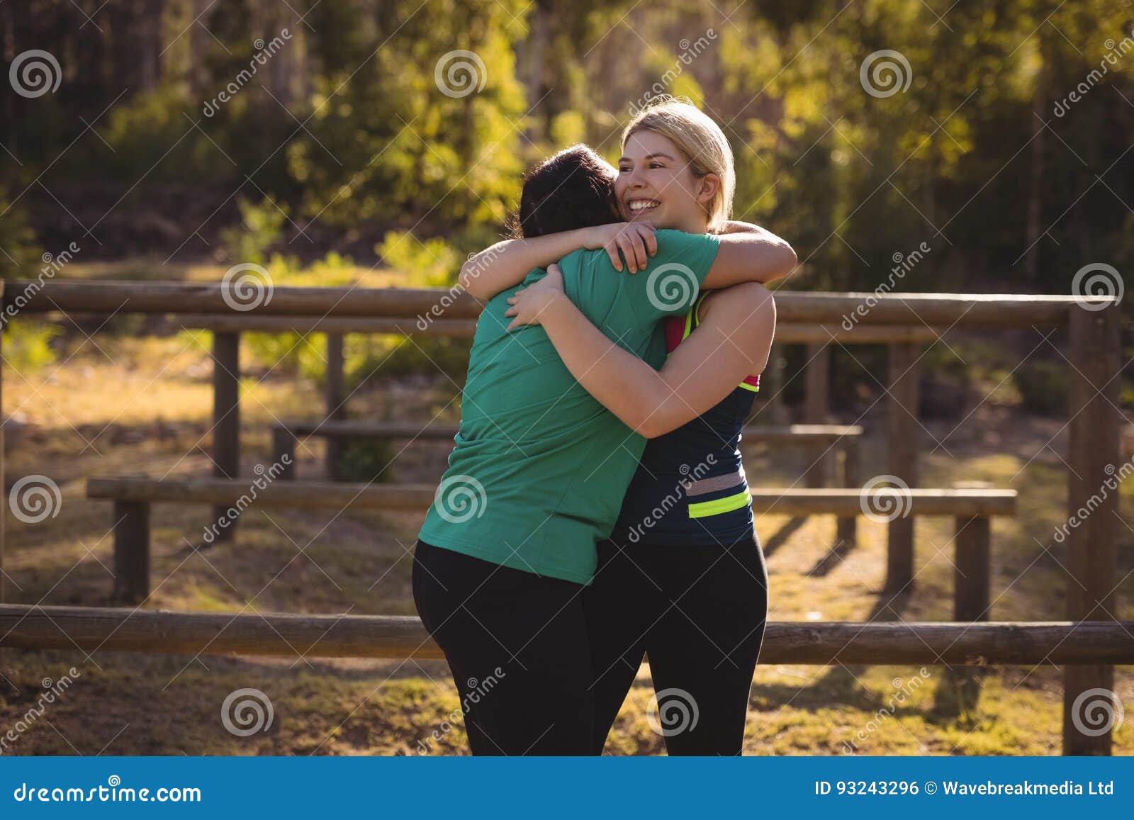 Happy Friends Embracing Each Other during Obstacle Course Stock Photo ...