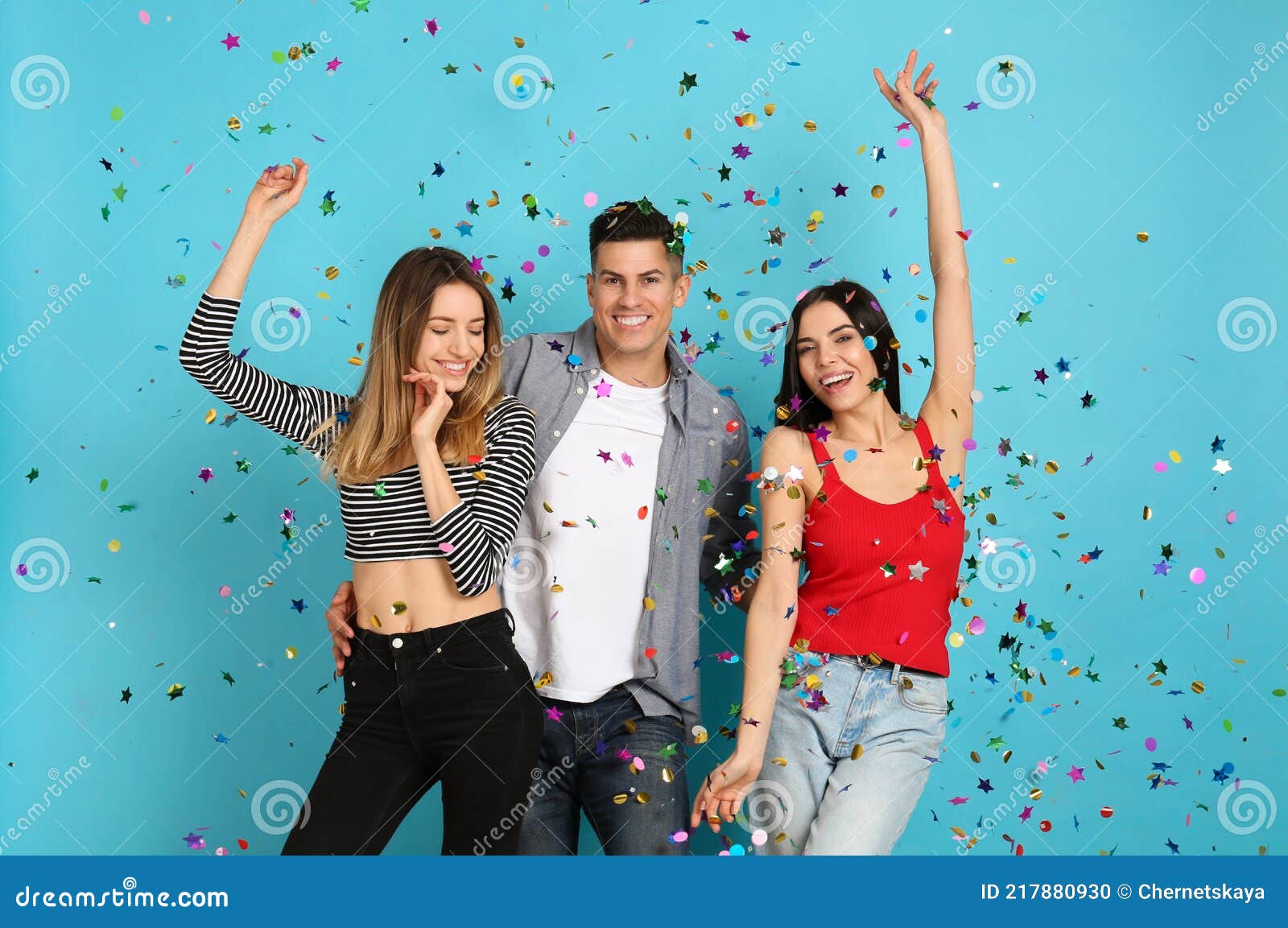 Happy Friends and Falling Confetti on Light Blue Background Stock Photo ...