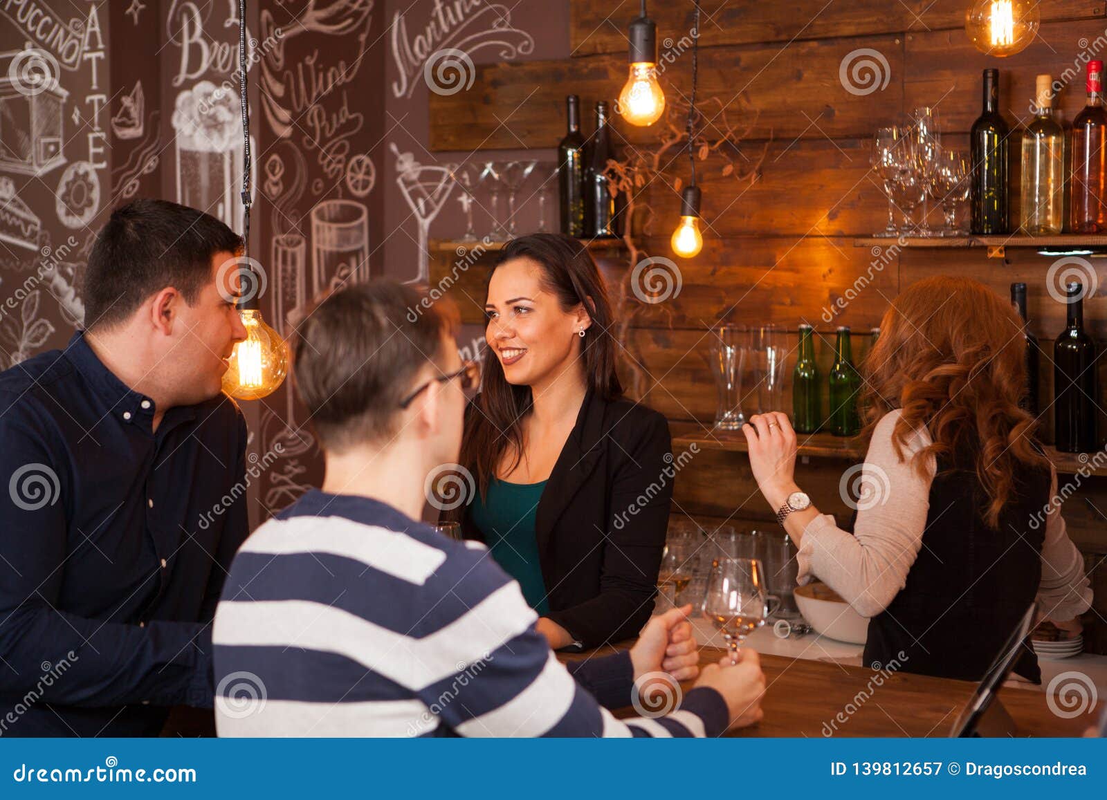 Happy Friends Interacting at Bar Counter in a Pub Stock Image - Image ...