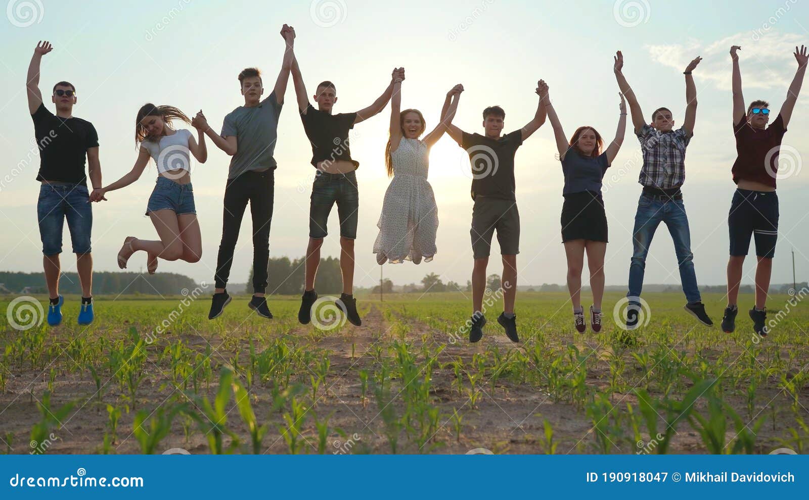 Happy Friends Jumping Holding Hands at Sunset. Stock Image - Image of ...
