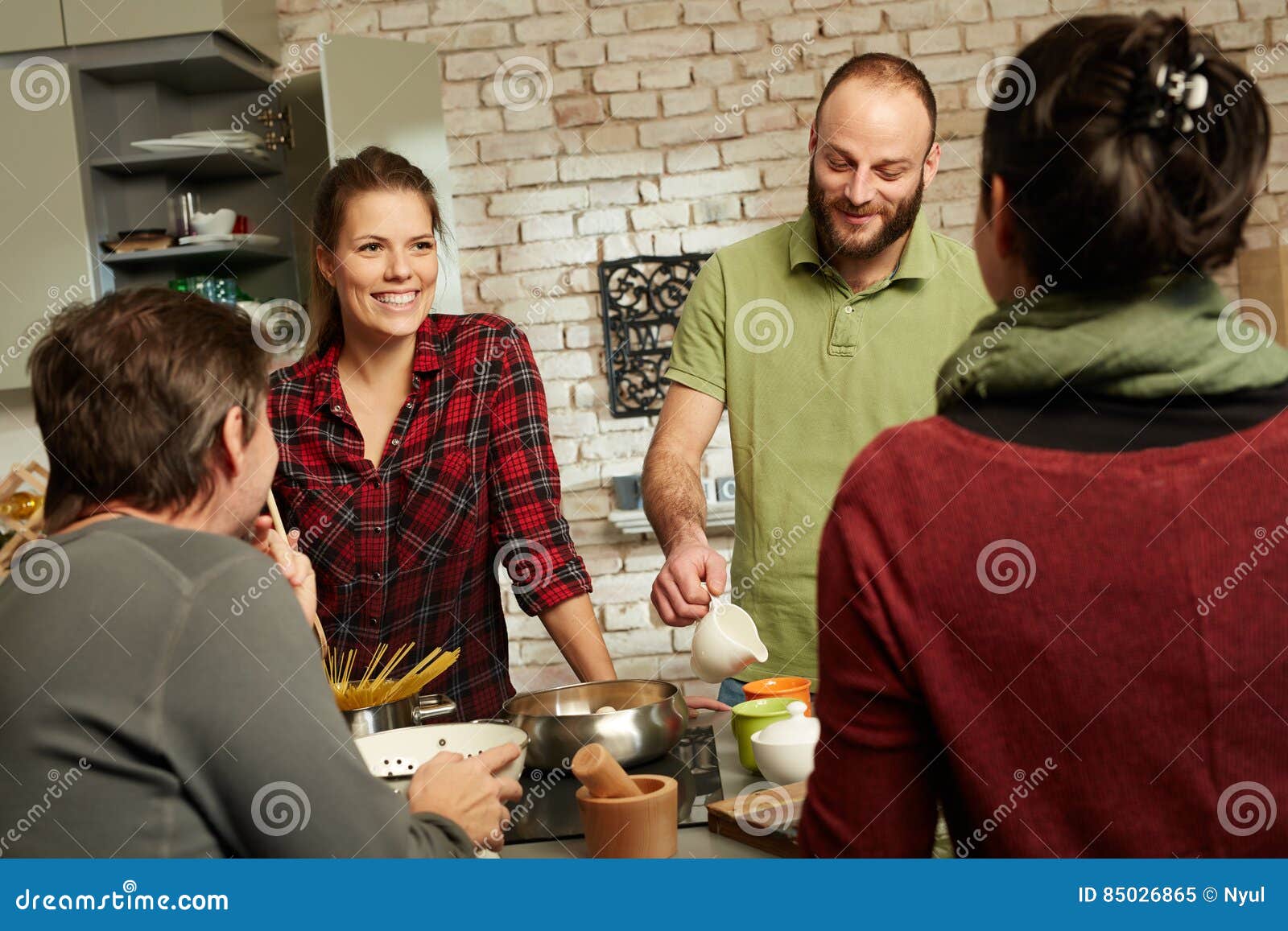 Happy friends in kitchen stock image. Image of group - 85026865