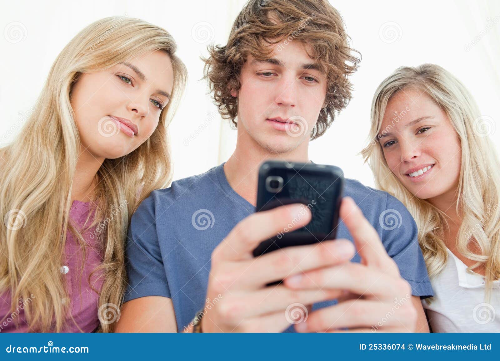 Happy Friends Looking at the Phone Stock Photo - Image of jeans ...