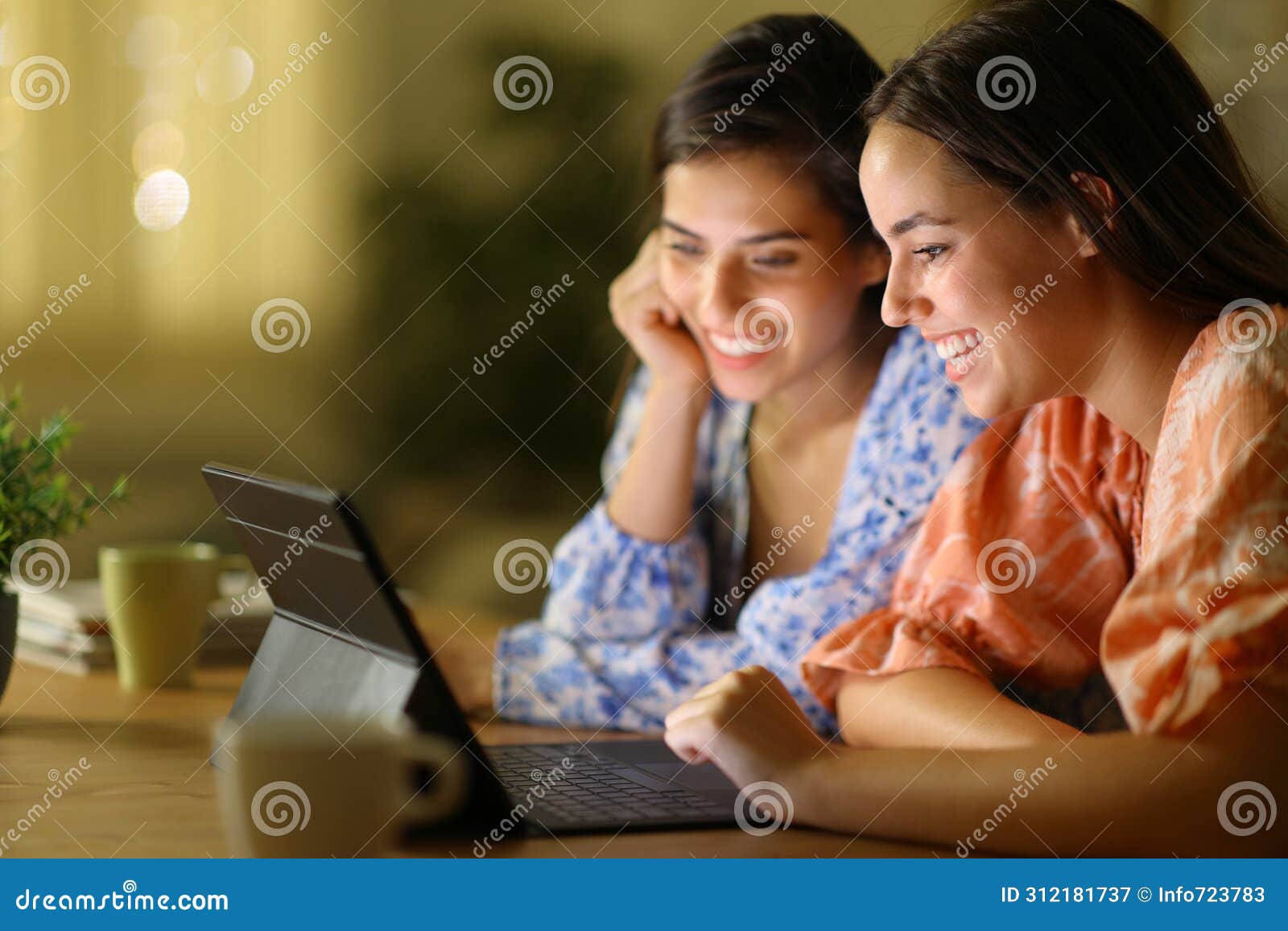 Happy Friends in the Night Watching Videos on Tablet Stock Image ...