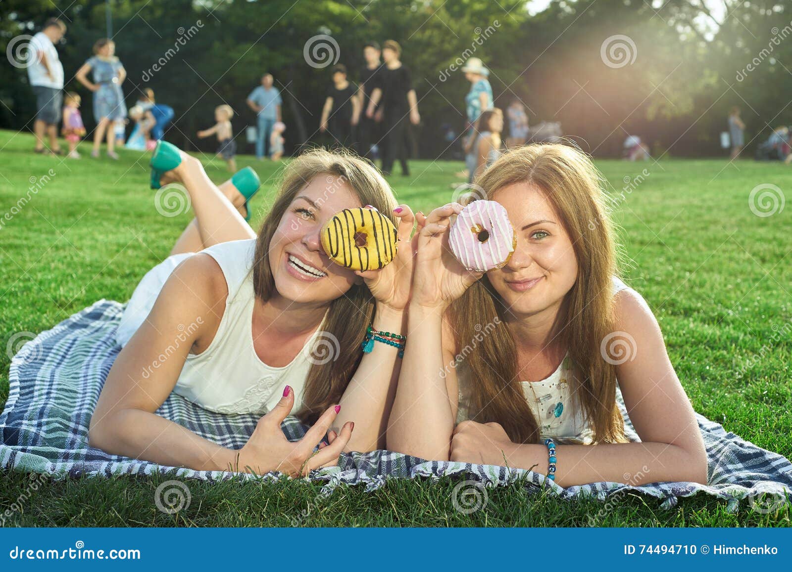 Happy friends in the park stock photo. Image of females - 74494710