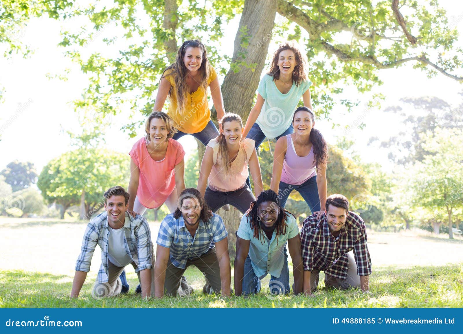 Happy Friends In The Park Making Human Pyramid Royalty-Free Stock Photo ...