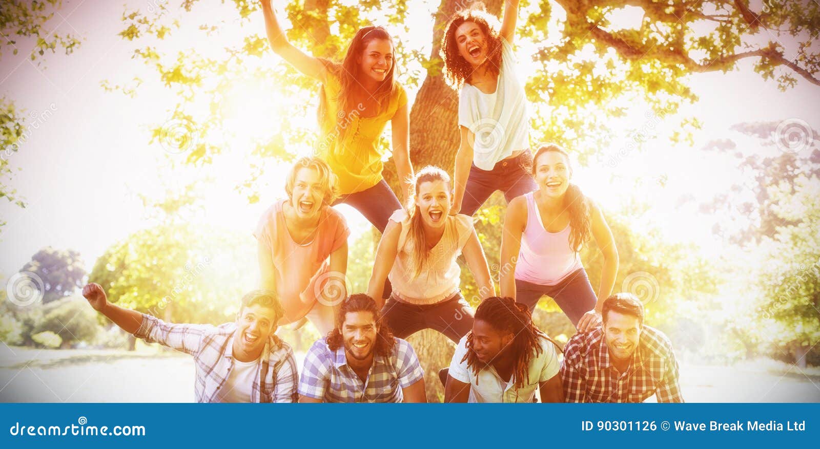 Happy Friends in the Park Making Human Pyramid Stock Photo - Image of ...