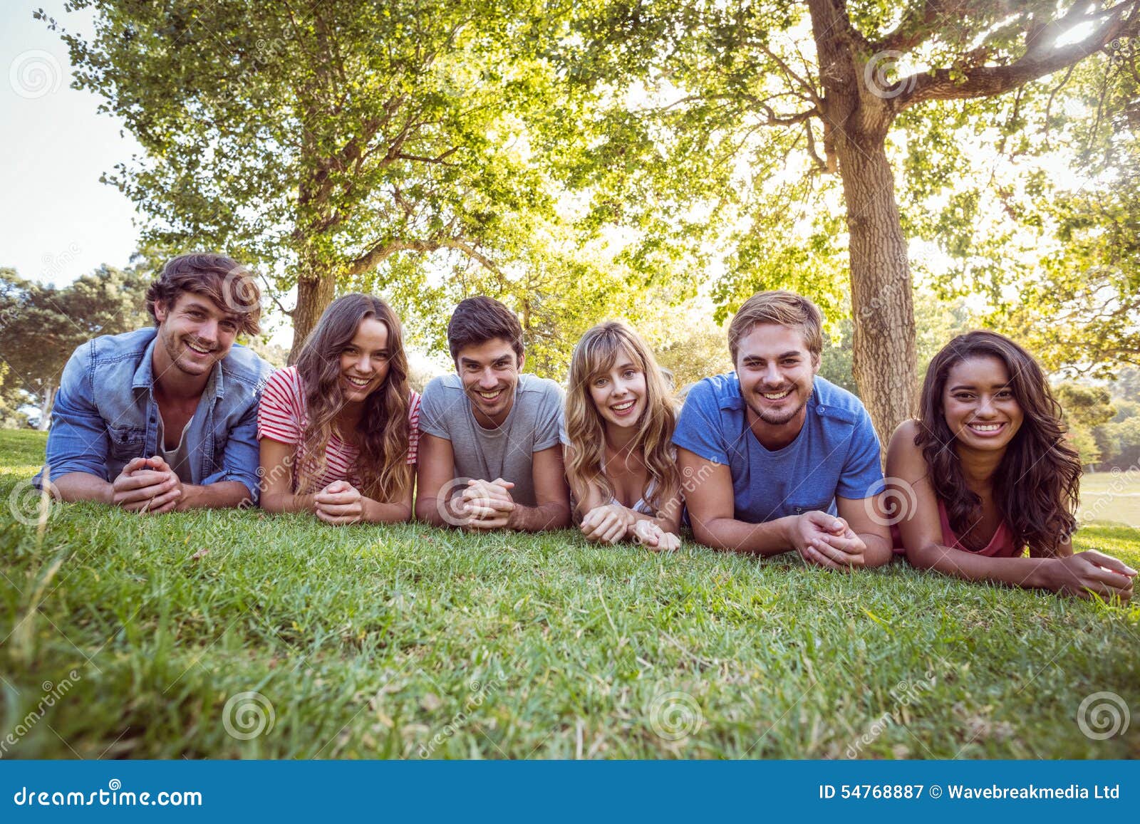 Happy friends in a park stock image. Image of fondness - 54768887