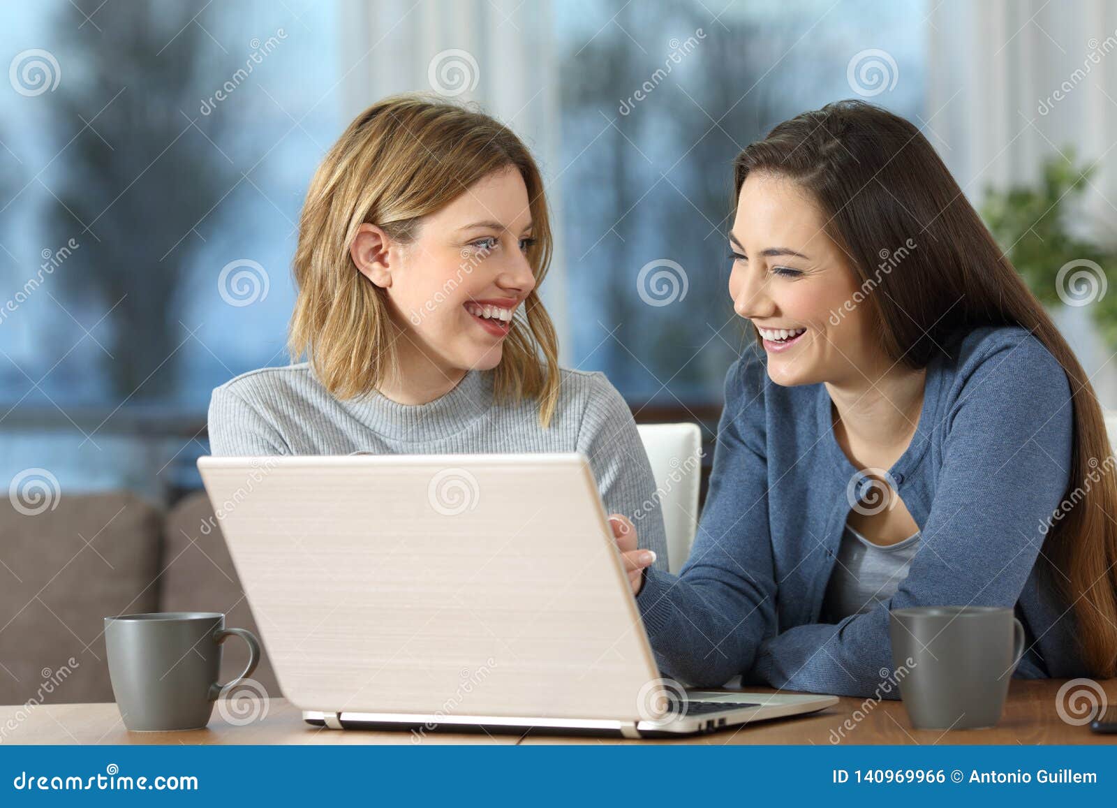 Happy Friends Using Laptop and Talking at Home Stock Photo - Image of ...