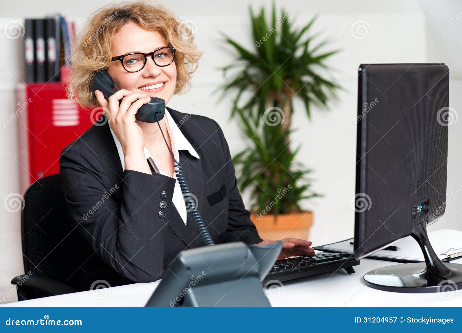 Happy Front Desk Lady Attending Clients Call Stock Image - Image of ...