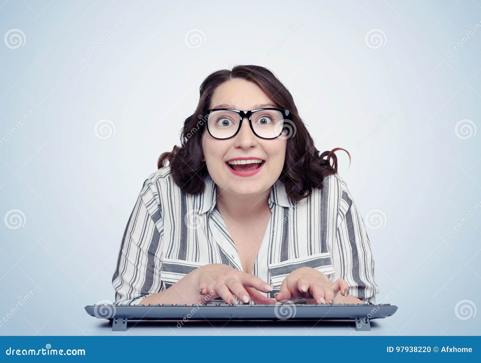 Happy Funny Girl Programmer in Glasses with Keyboard in Front of ...
