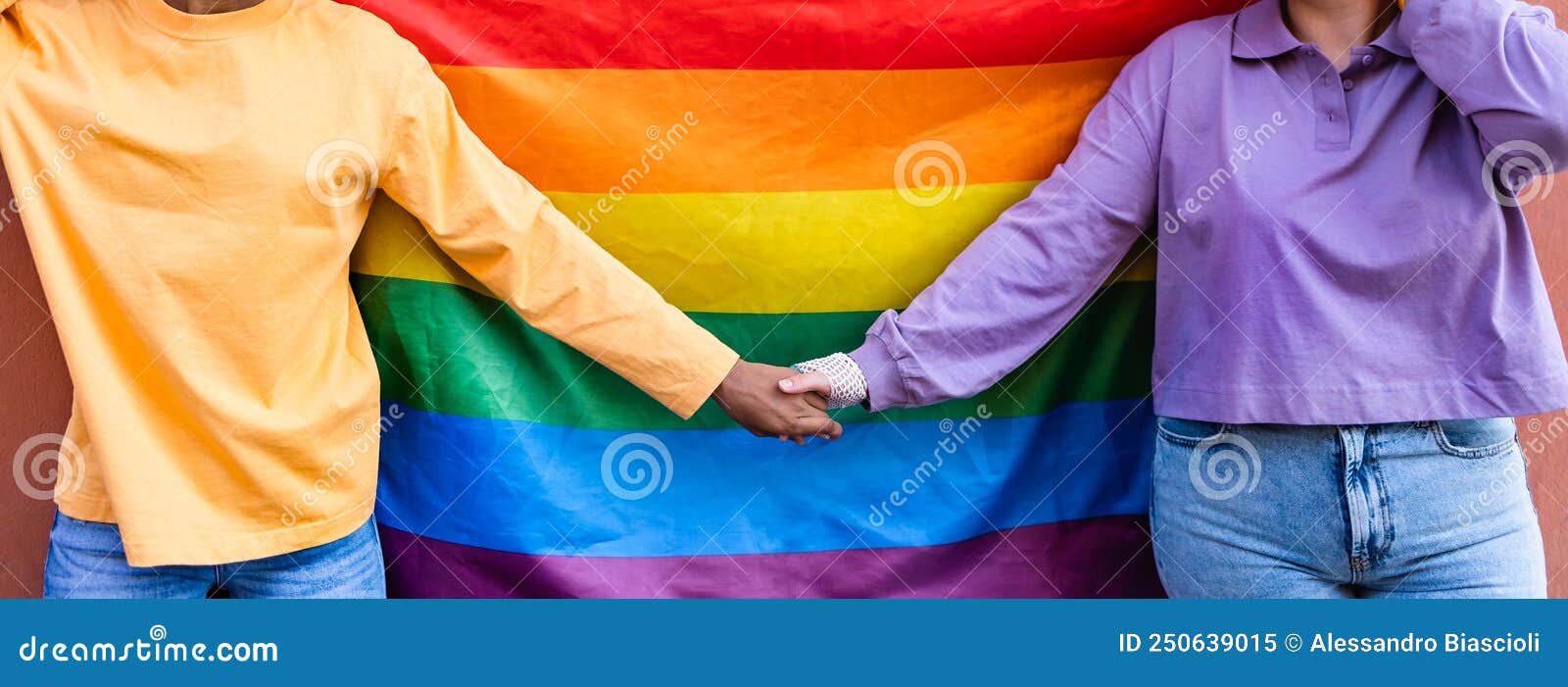 Happy Gay Couple Holding Hands While Celebrating Lgbtq Pride Parade