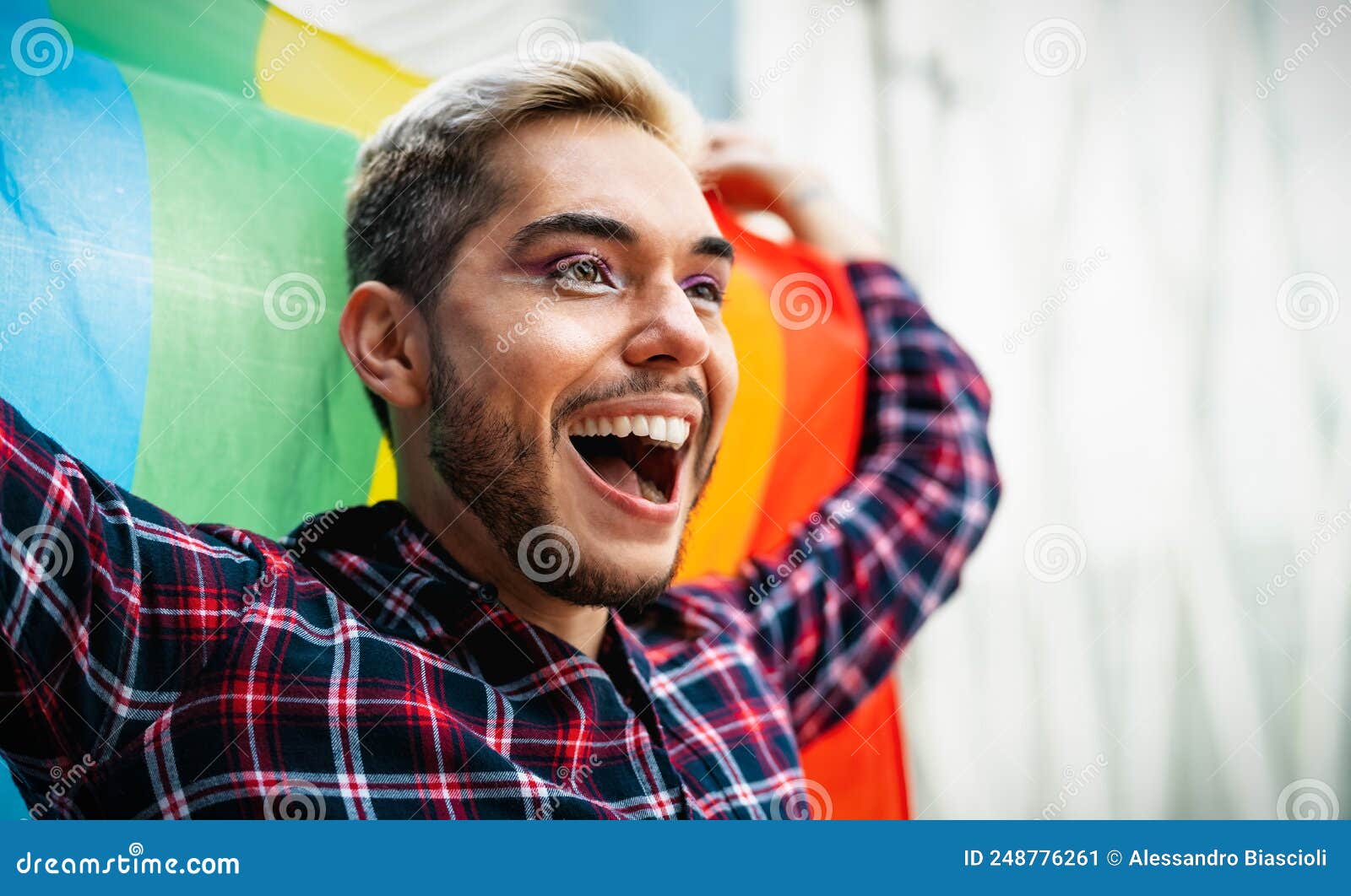 Happy Gay Man Having Fun Holding Rainbow Flag Symbol Of Lgbtq Stock