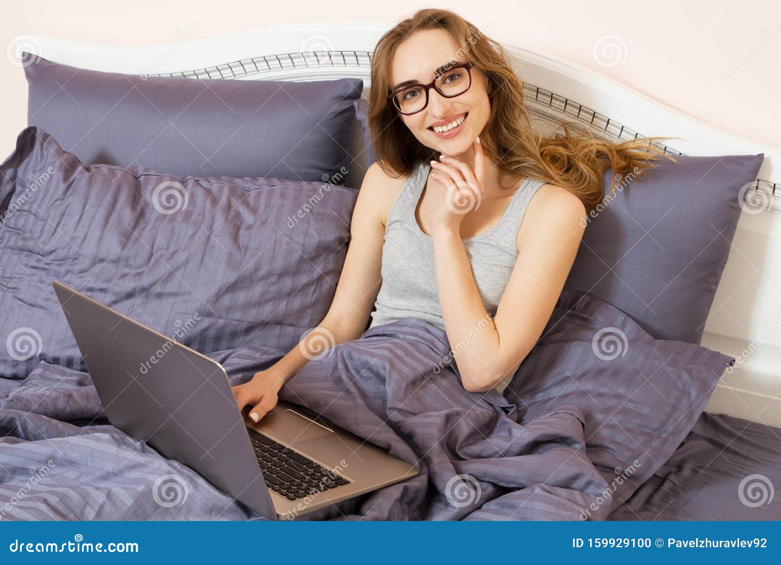 Happy Girl Browsing Internet in a Laptop in the Bed at Home Stock Photo ...