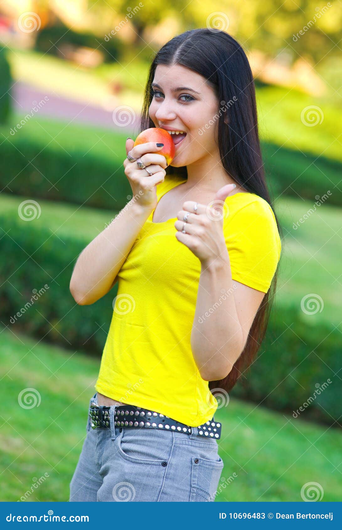 Happy girl eating apple stock image. Image of eating - 10696483