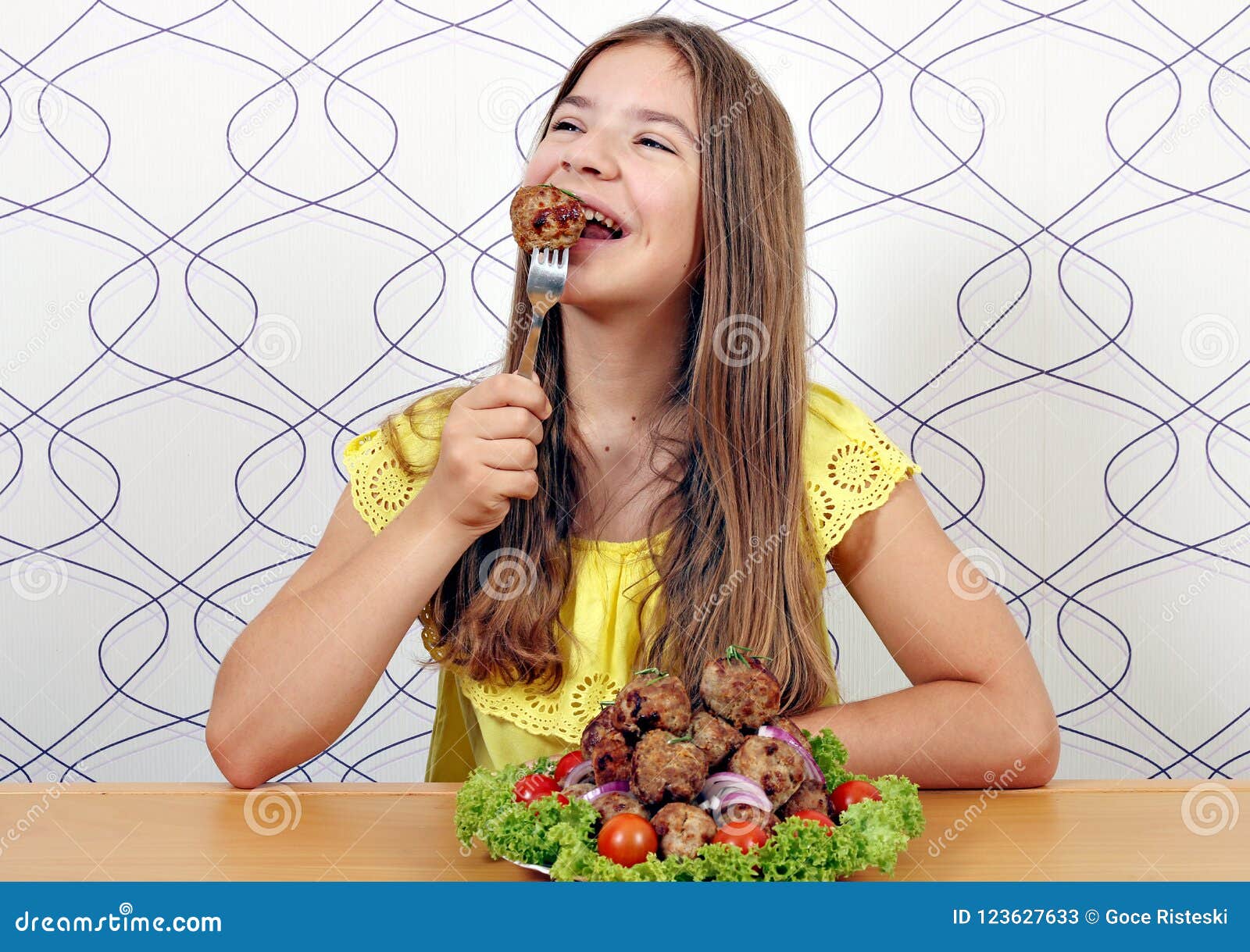 Happy girl eats meatball stock image. Image of girl - 123627633