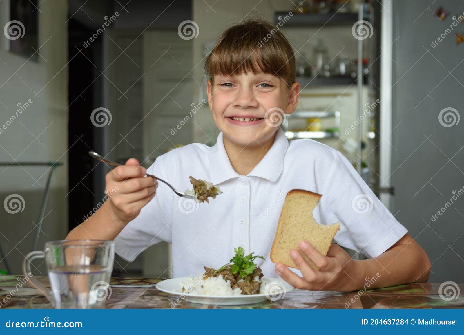 Happy Girl Happily Eats the Second Dish and Looks into the Frame with a ...