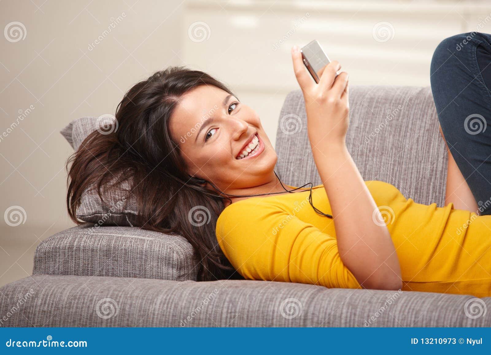 Happy Girl Holding Phone on Sofa at Home Stock Image - Image of ...