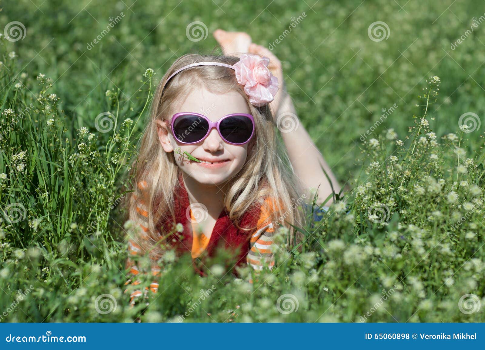 Happy girl lay in grass stock photo. Image of field, healthy - 65060898