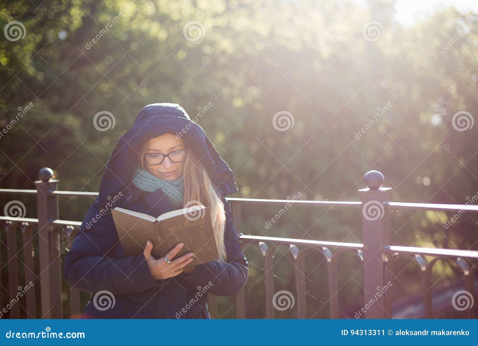 Happy Girl Reading a Book at the Railing. Stock Image - Image of book ...