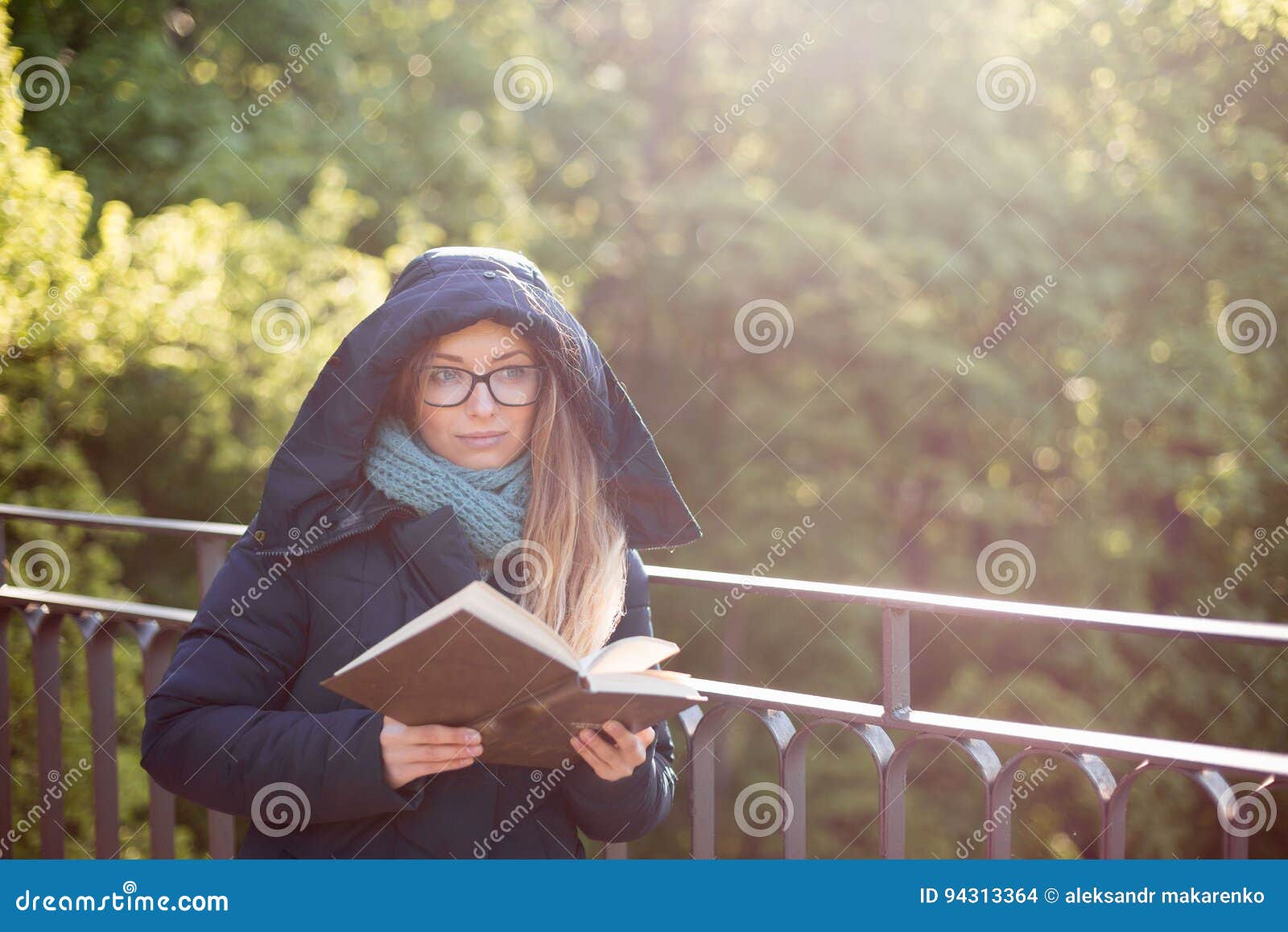Happy Girl Reading a Book at the Railing. Stock Photo - Image of shelf ...