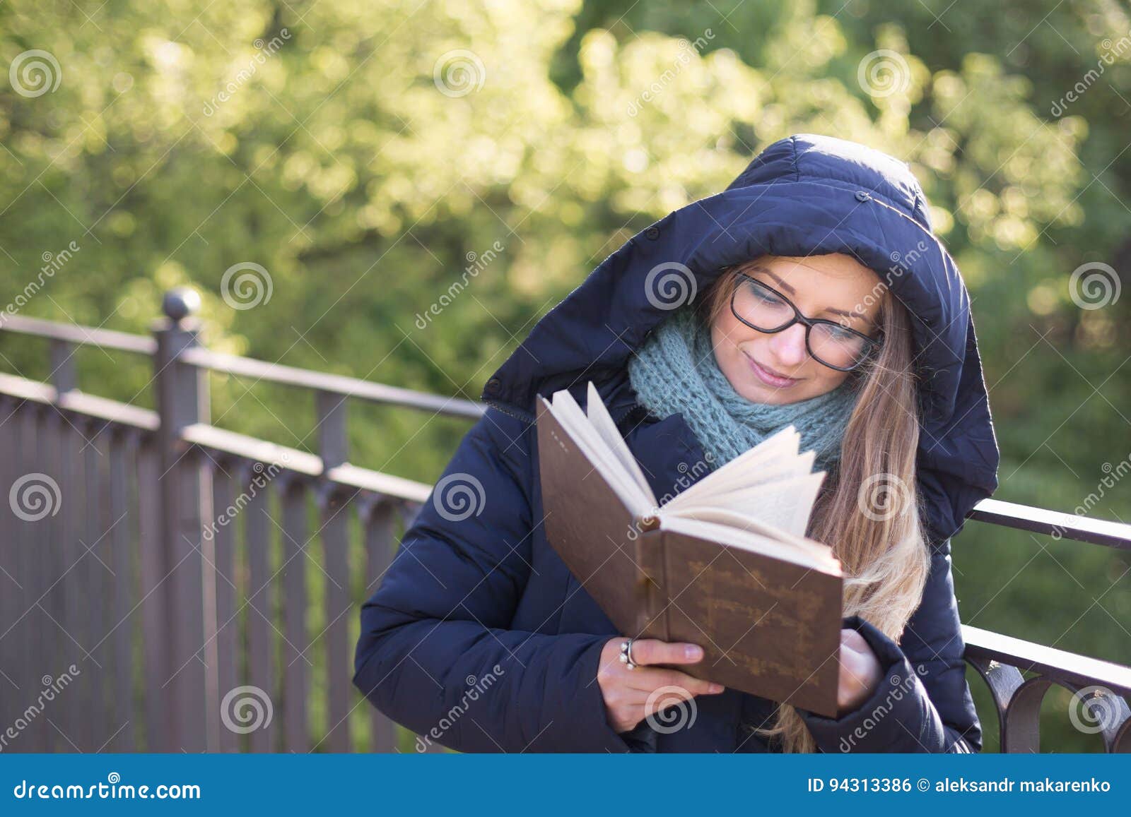 Happy Girl Reading a Book at the Railing. Stock Photo - Image of ...