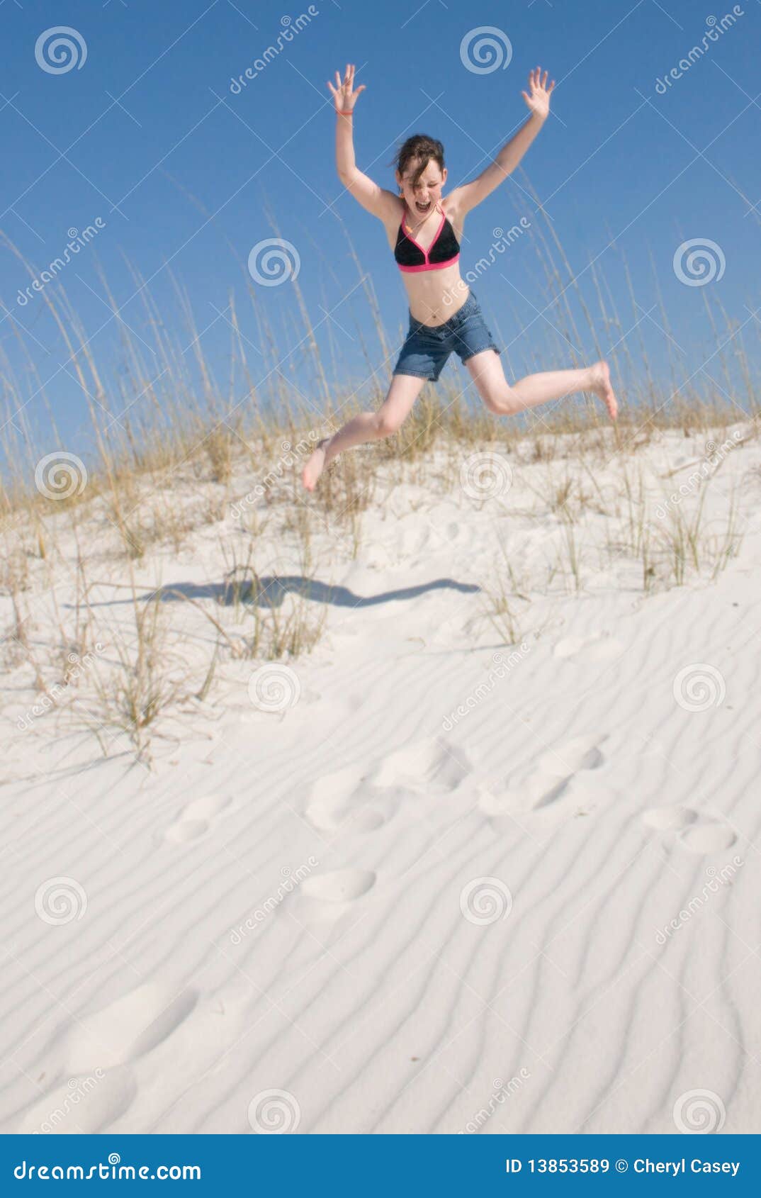 Happy girl on sand dune stock image. Image of grass, pensacola - 13853589