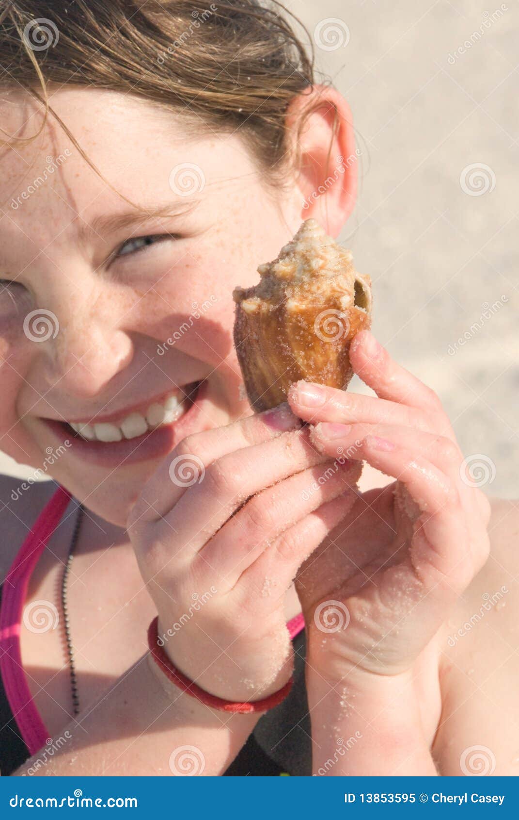 Happy girl with seashell stock image. Image of collecting - 13853595
