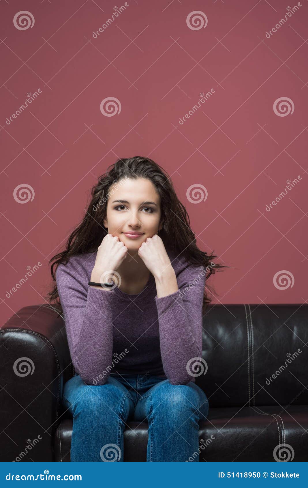 Happy girl sitting on sofa stock photo. Image of beautiful - 51418950