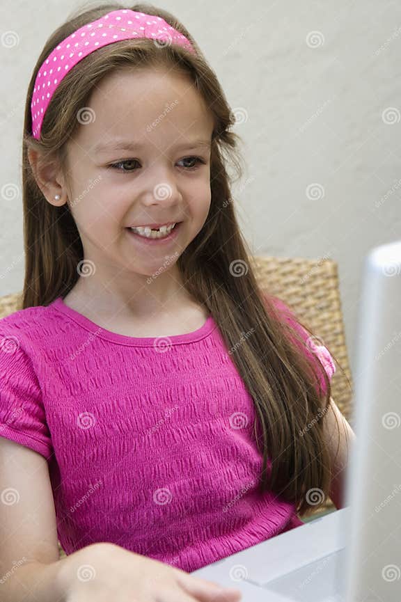 Happy Girl Using Laptop stock image. Image of pink, indoors - 29662437