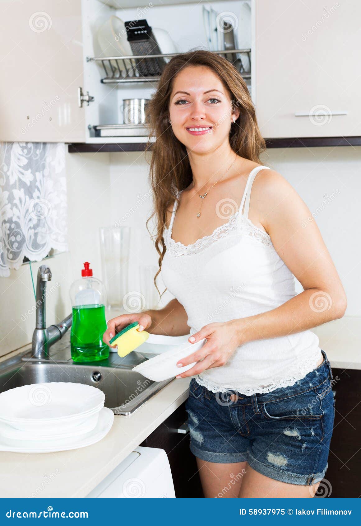 Happy girl washing dishes stock image. Image of sink - 58937975