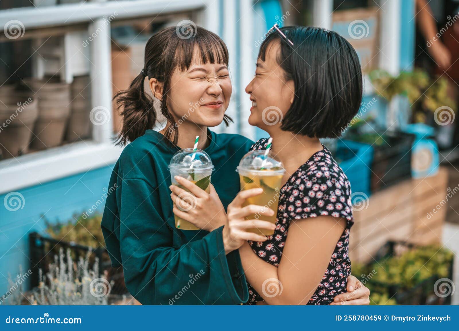 Two Girls with Lemonade in Hands Spending Time Together and Looking ...