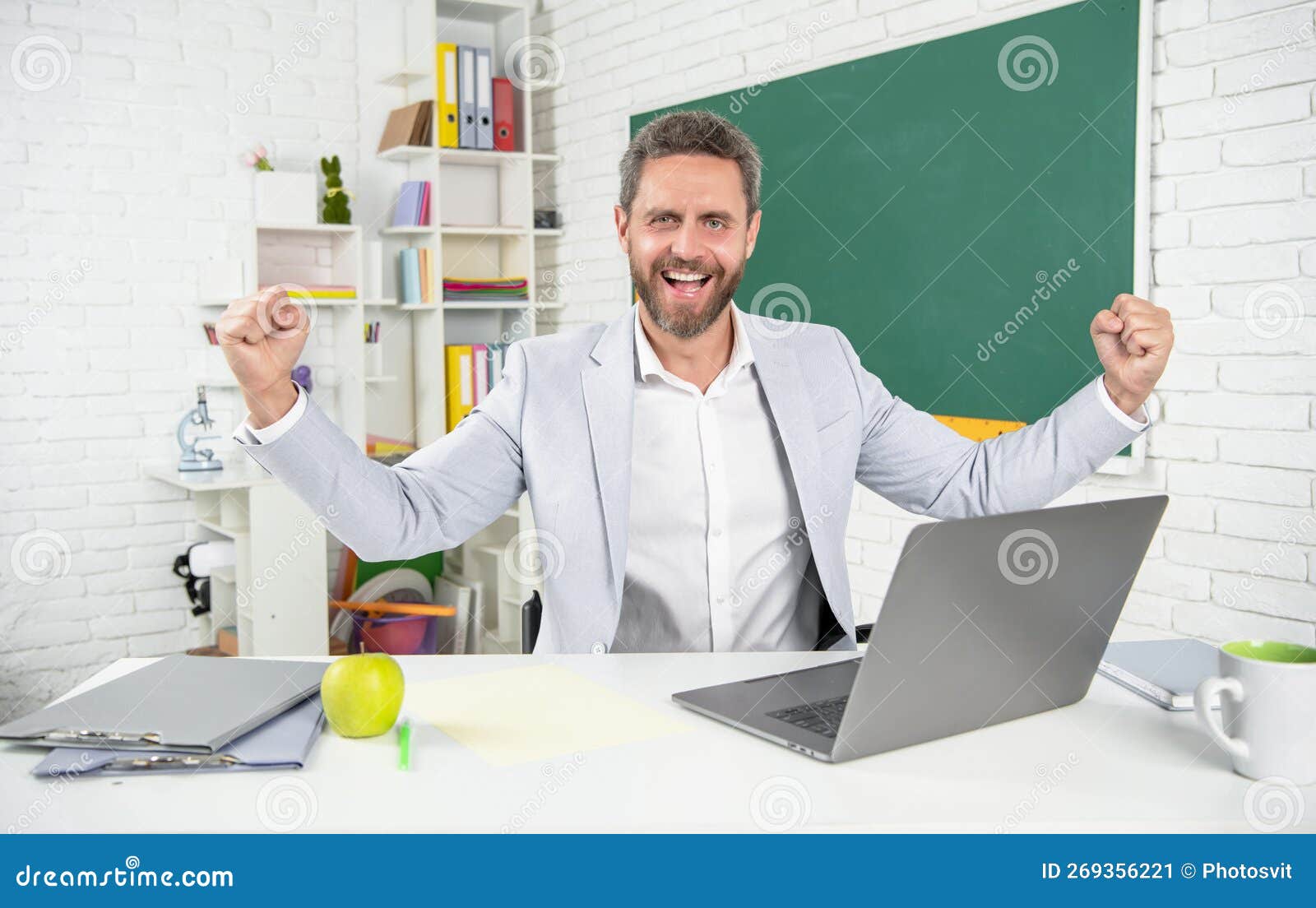 Happy Glad School Teacher in Classroom with Computer at Blackboard ...
