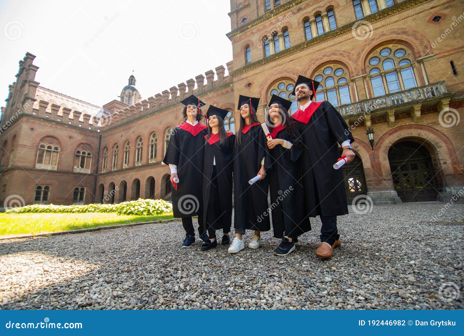 Happy Graduates Raised Their Hands With Scrolls Of Diplomas Royalty ...