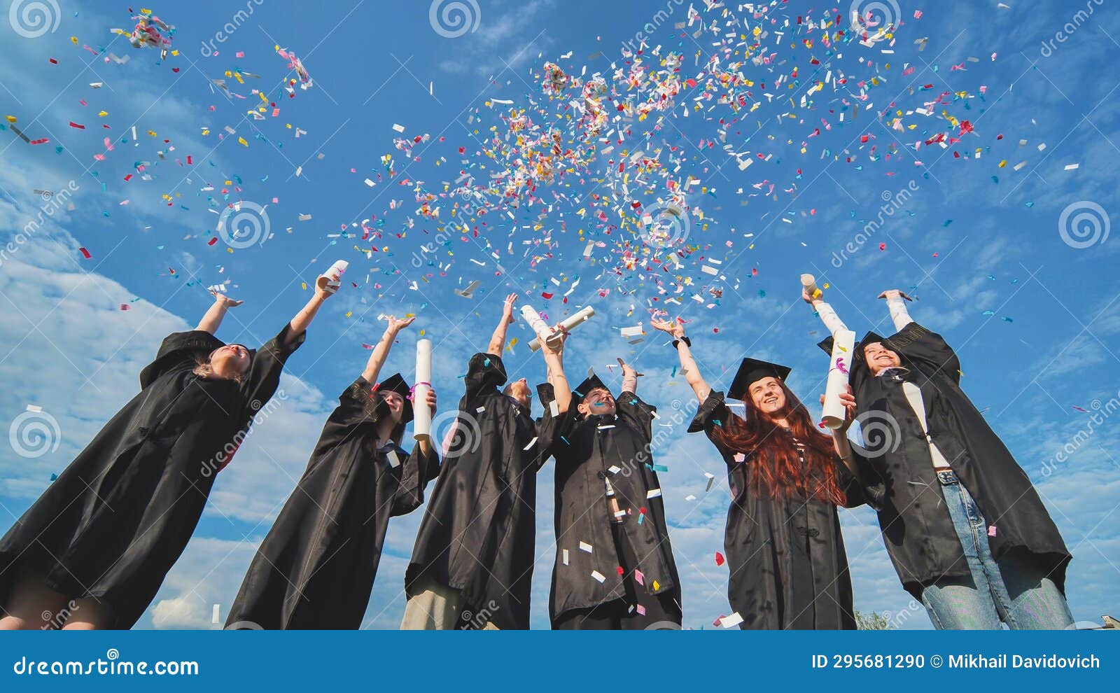 Happy Graduates Throw Colorful Confetti Against a Blue Sky. Stock Photo ...