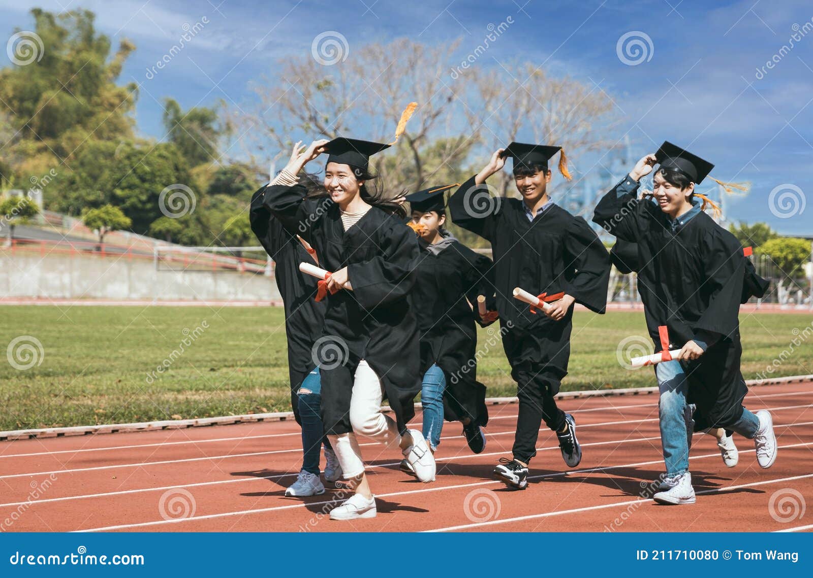 Happy Graduation Students Holding Diploma and Running on the Stadium at ...