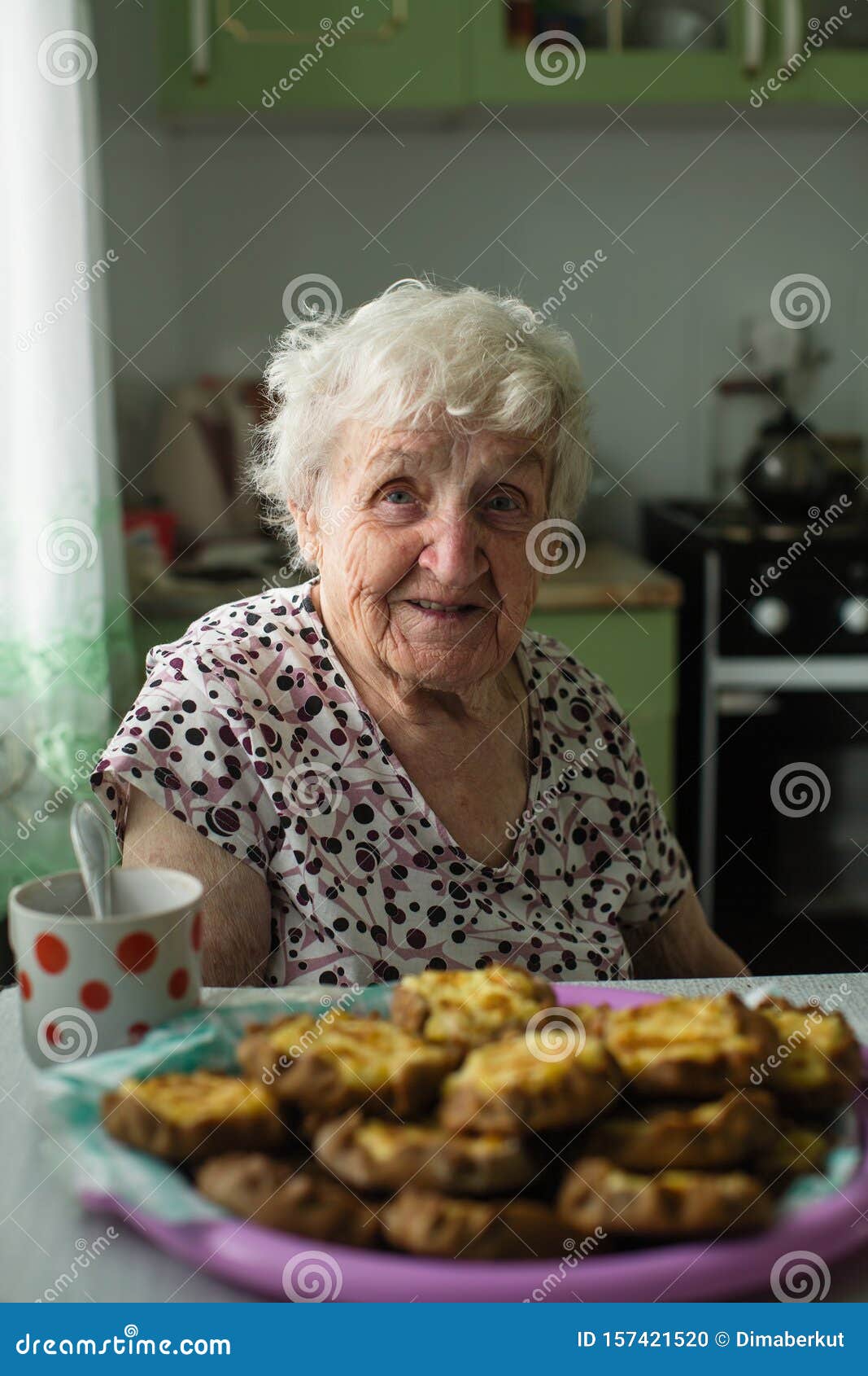 Happy Grandma is Sitting in the Kitchen with Pastries Stock Photo ...