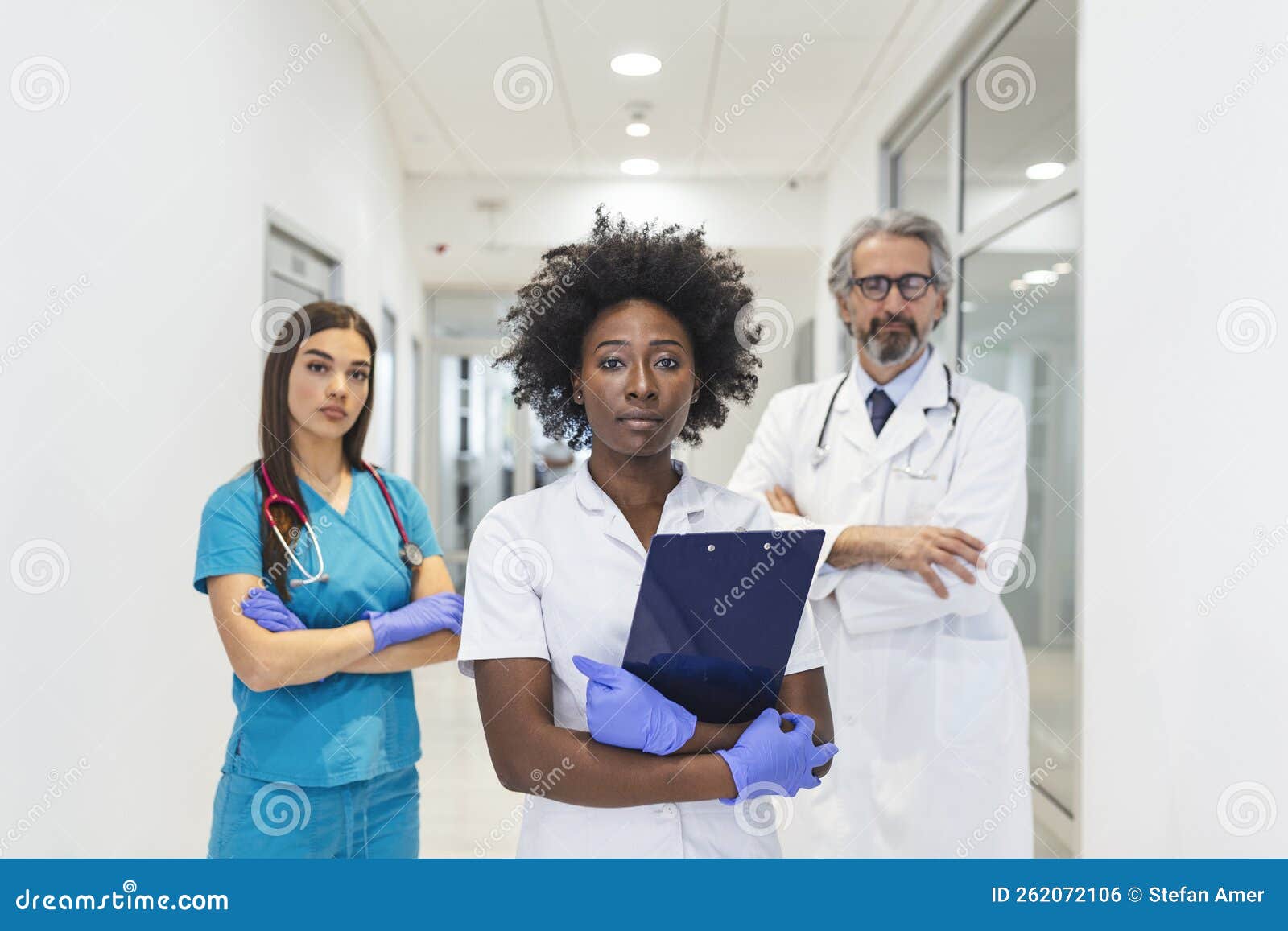 Happy Group of Doctors at the Hospital Looking at the Camera Smiling ...