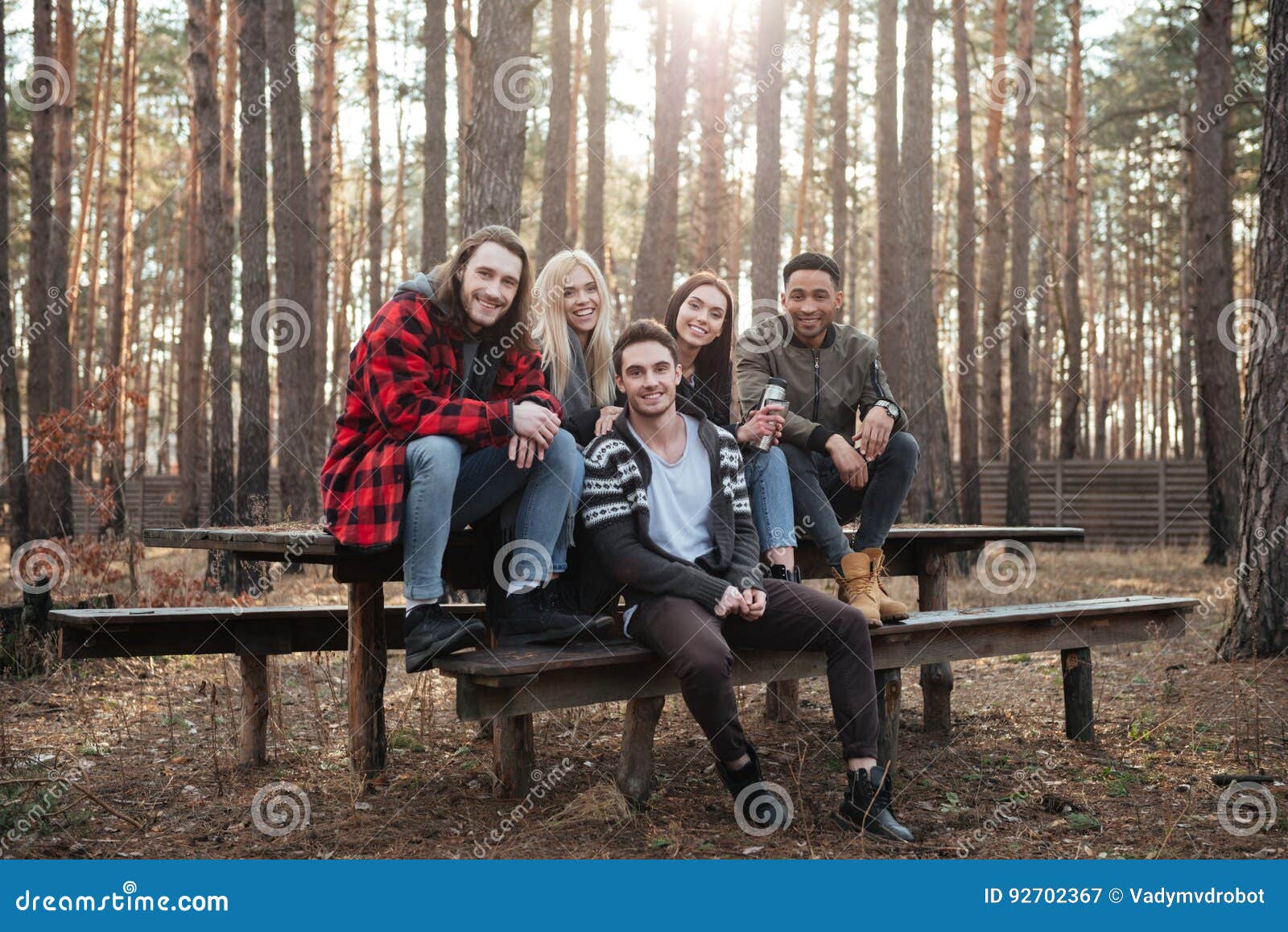 Happy Group of Friends Sitting Outdoors in the Forest. Stock Image ...
