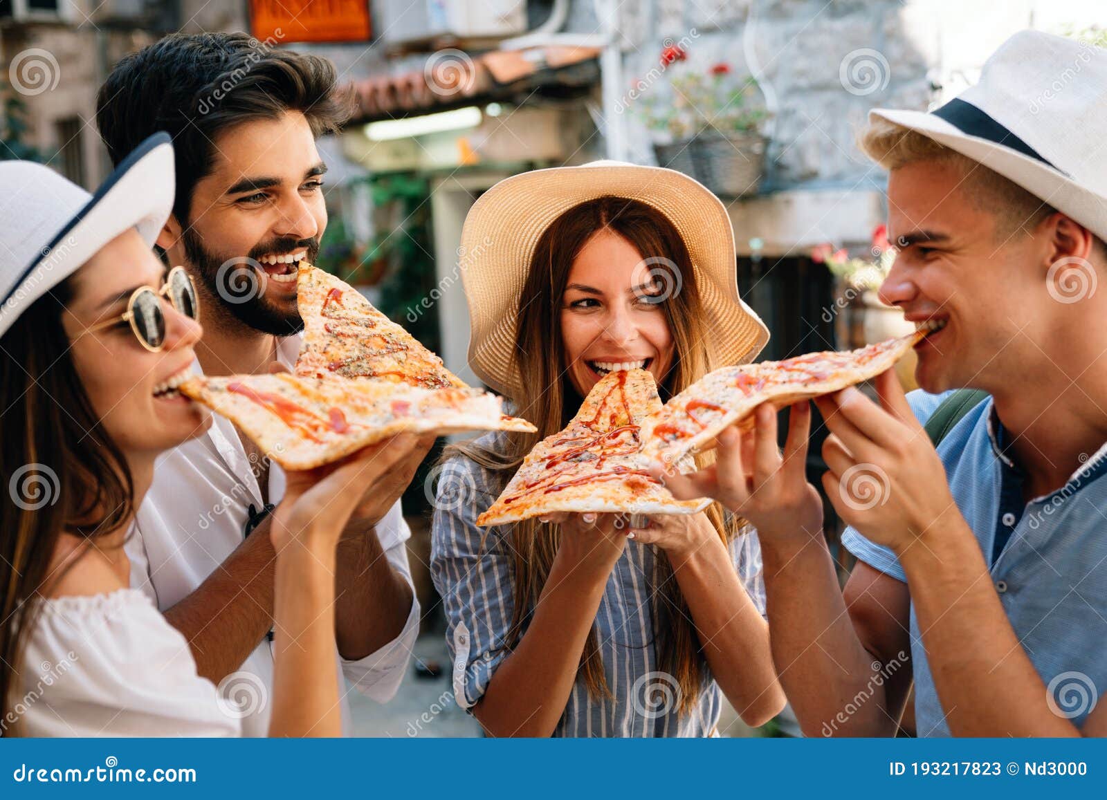 Happy Group of People Eating Pizza Outdoors,they are Enjoying Together ...