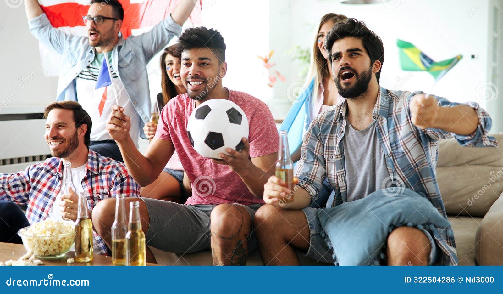 Happy Group of Young Friends Watching Television and Supporting Their ...