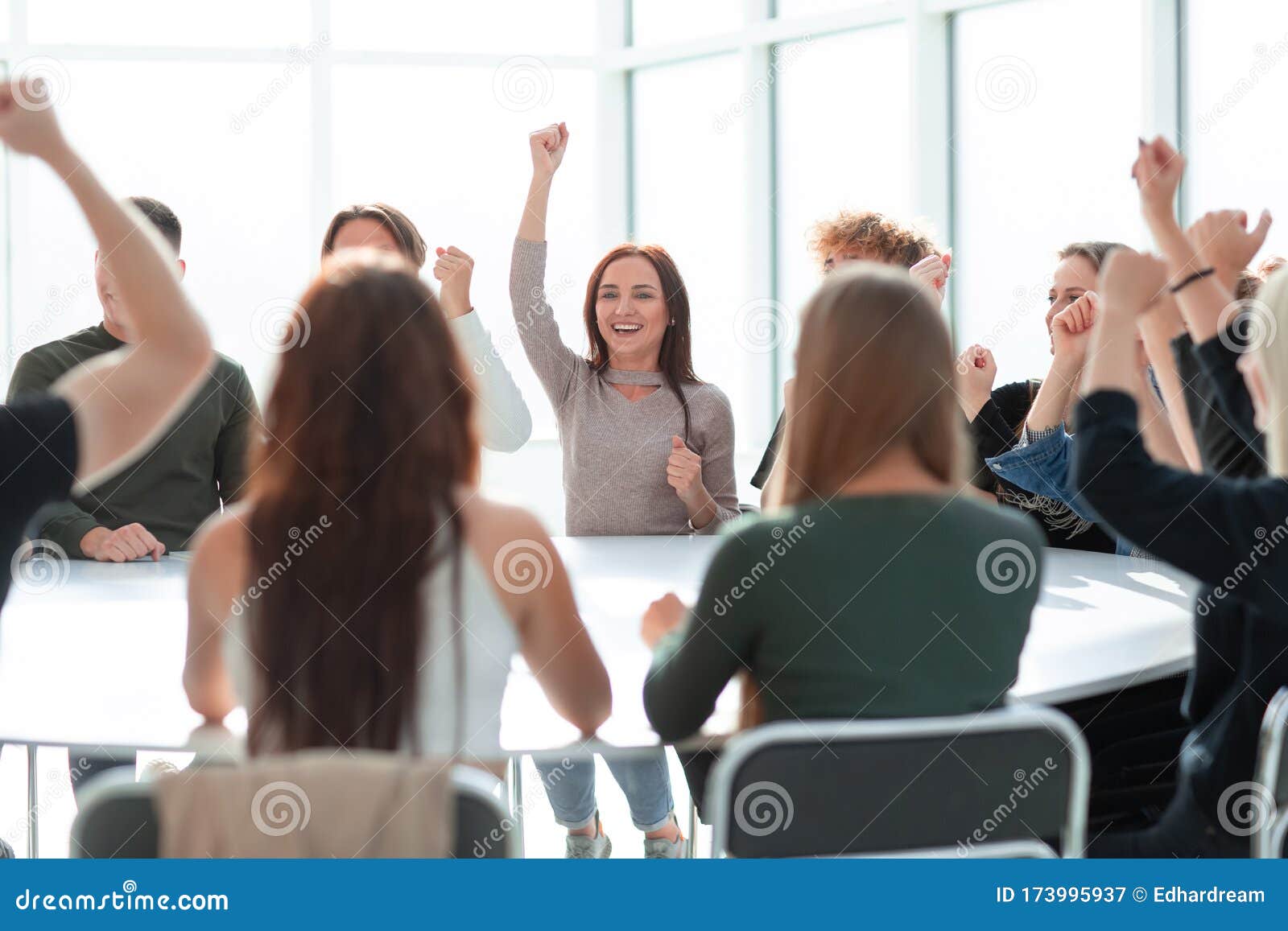 Happy Group of Young People Sitting at a Round Table Stock Image ...