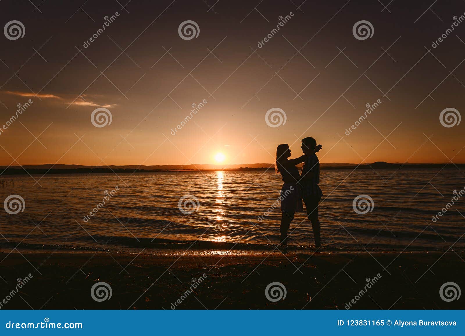 Guy and Girl Hugging the Sea at Sunset Stock Image - Image of romantic ...