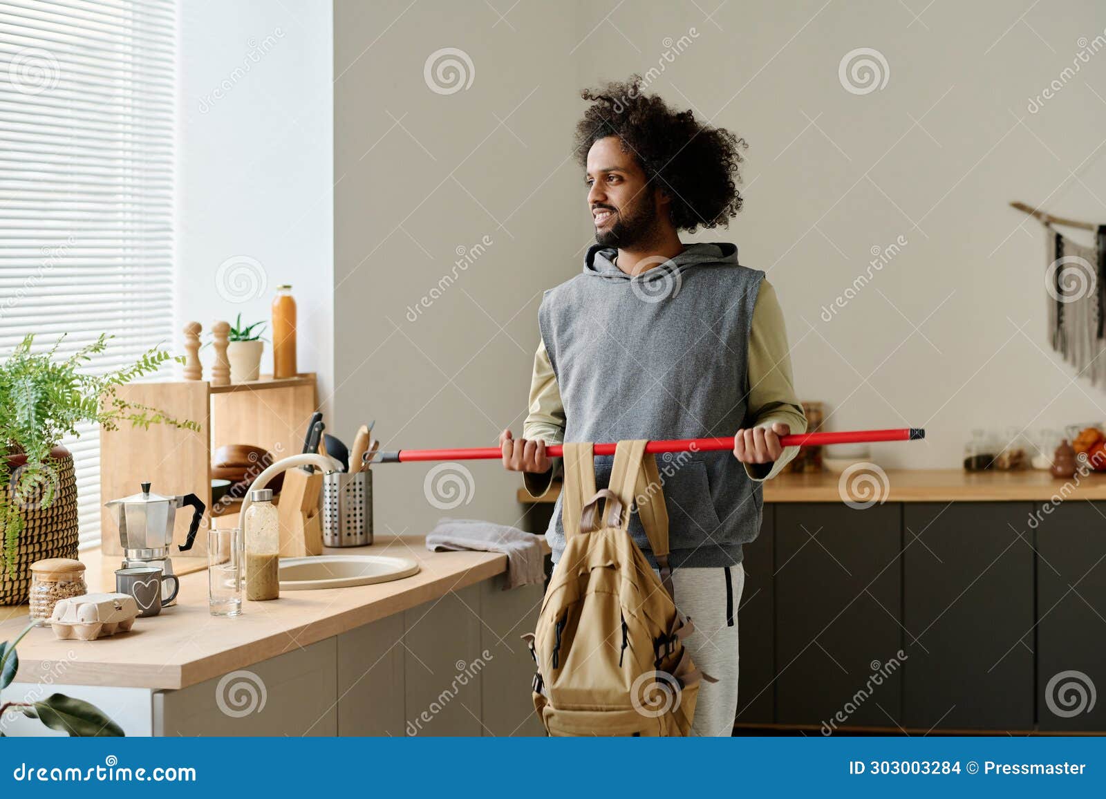 Happy Guy Lifting Backpack on Stick Stock Photo - Image of ...