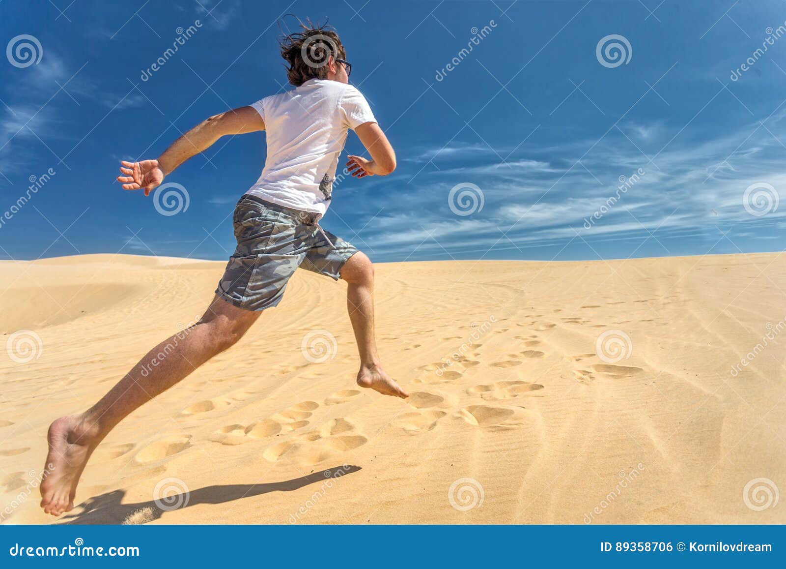 Happy guy running on sand stock photo. Image of sand - 89358706