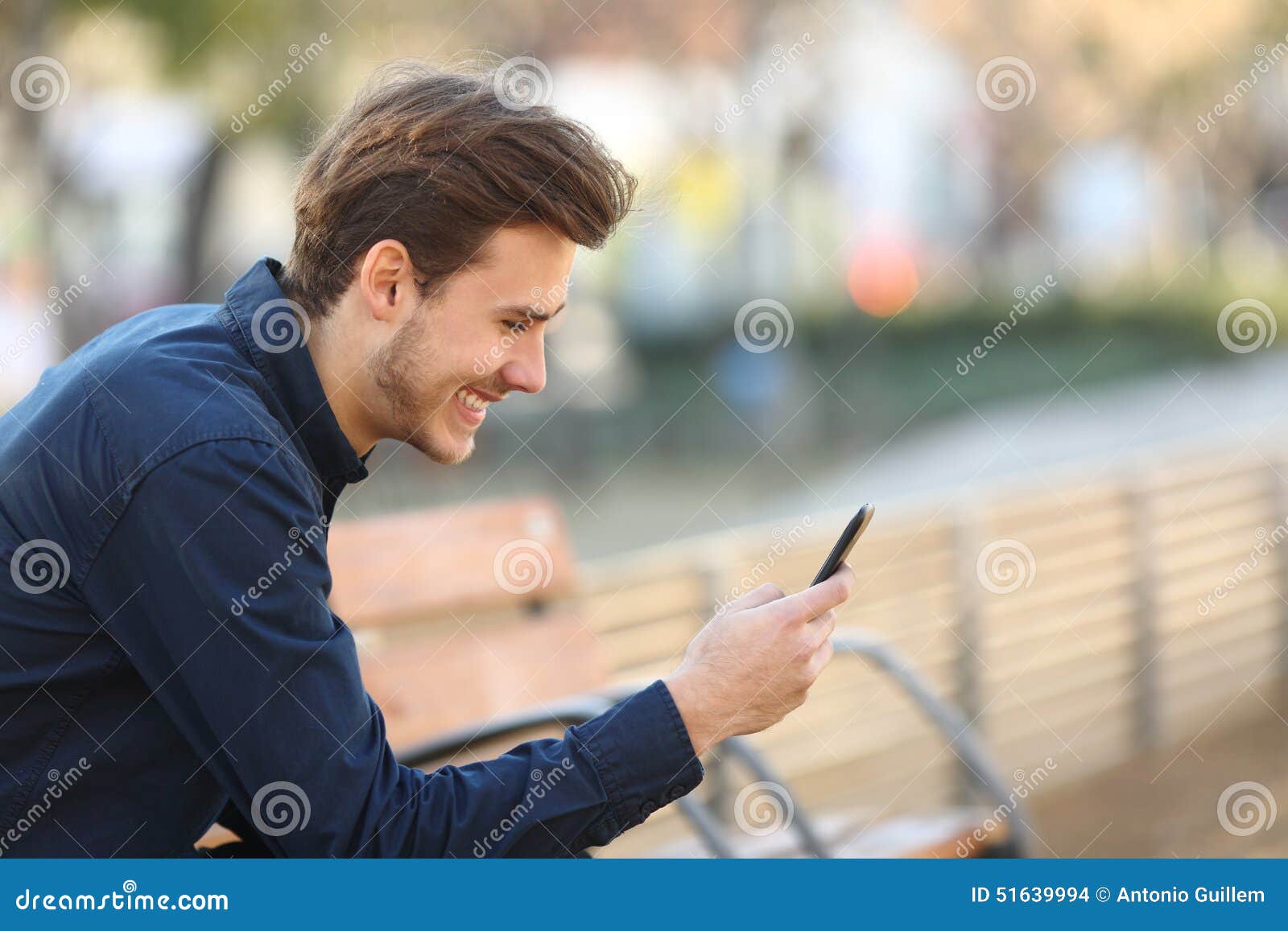 Happy Guy Using a Smart Phone in a Park Stock Photo - Image of casual ...
