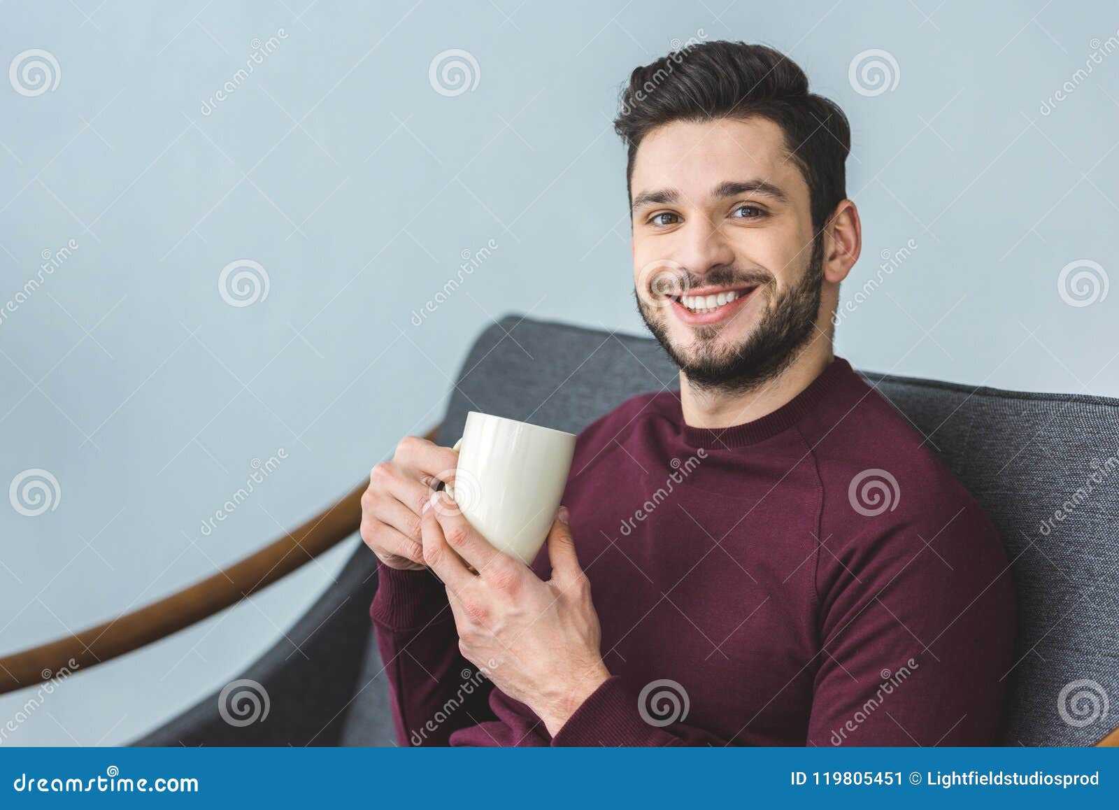 Happy Handsome Bearded Man Holding Cup with Drink and Sitting Stock ... Happy Handsome Bearded Man Holding Cup with Drink and Sitting Stock ...
