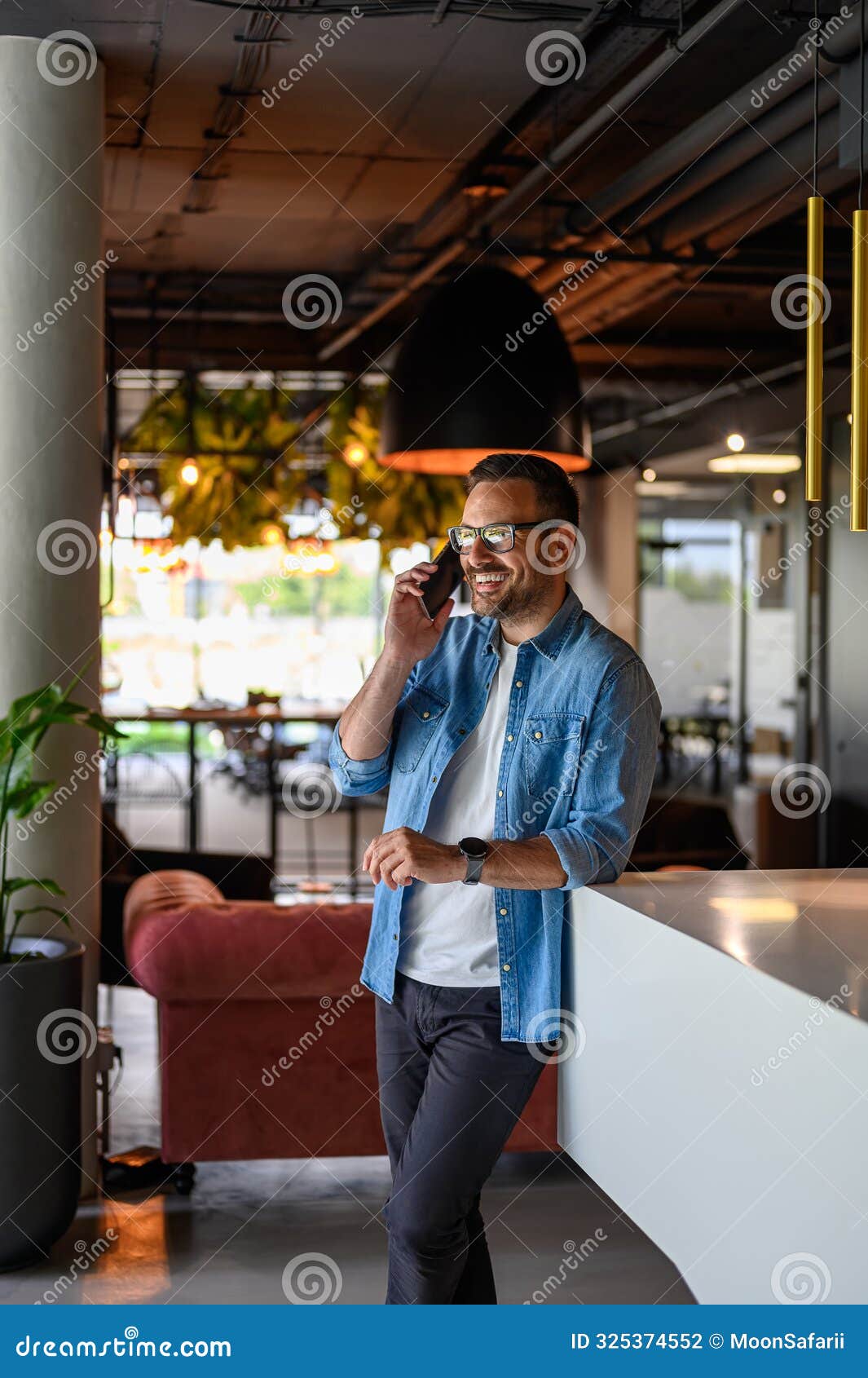 Happy Handsome Engineer in Glasses Discussing with Client Over Phone ...