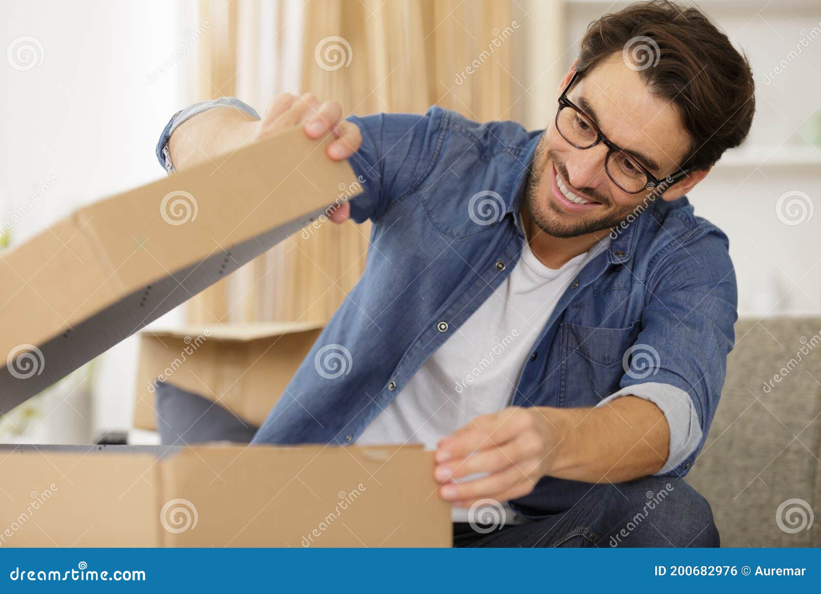 Happy Handsome Man Opening Parcel Stock Photo - Image of postal, goods ...