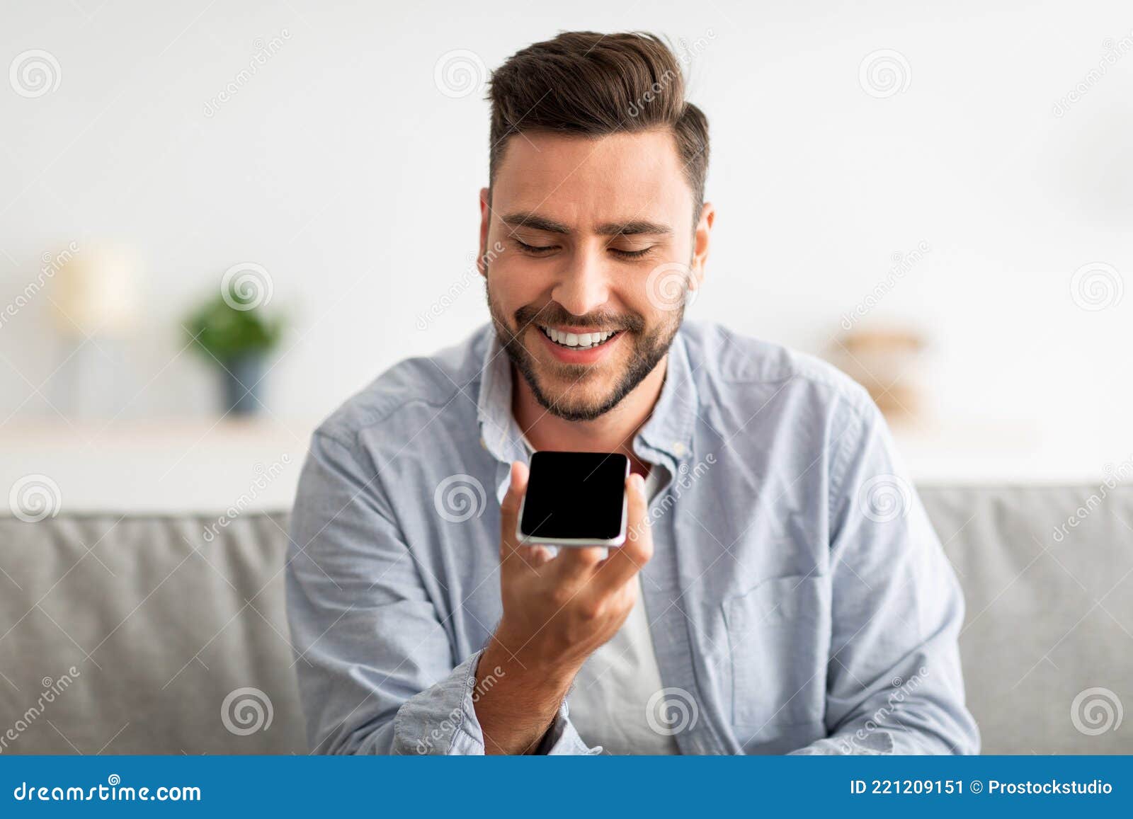 Happy Handsome Man Recording Voice Message on Smartphone or Using ...