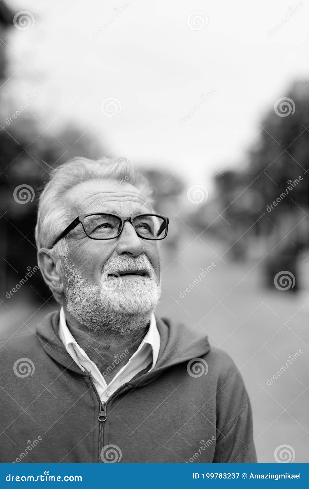 Happy Handsome Senior Bearded Man Smiling While Thinking And Looking Up